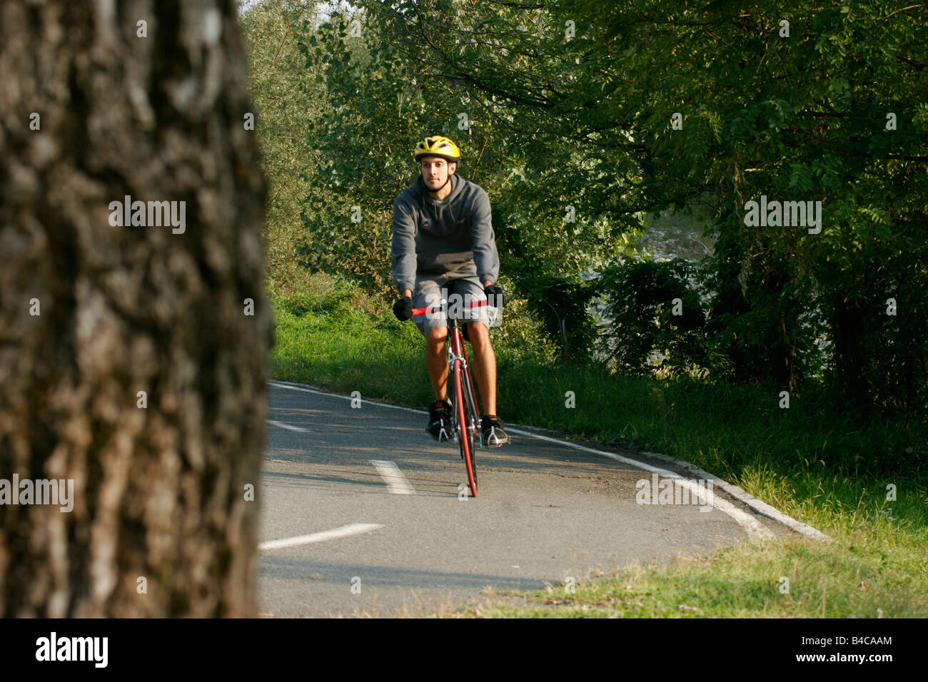 Boy rides his red bike on a cycleway Stock Photo - Alamy