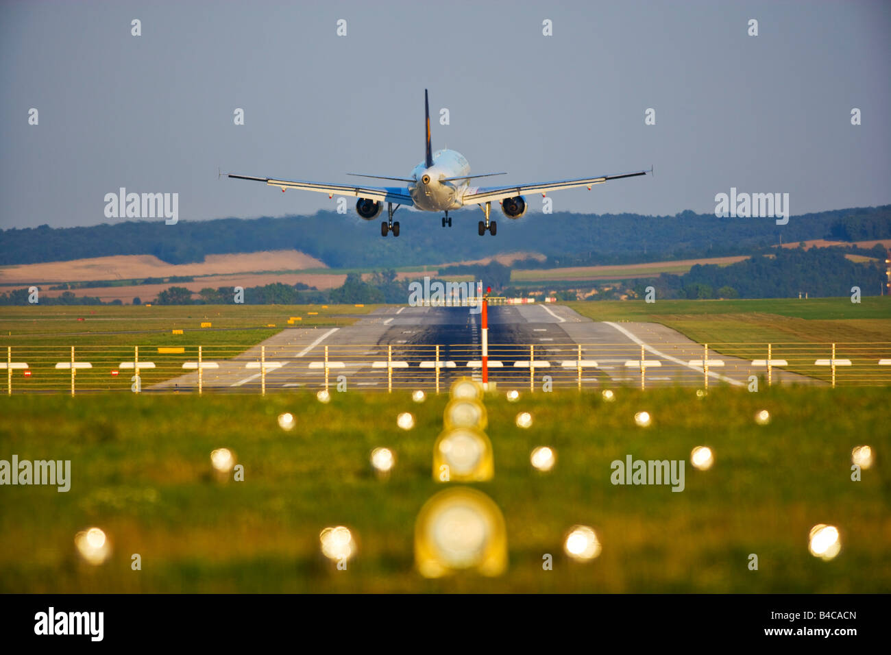 Landing aircraft on final approach. The runway lights can be seen in ...