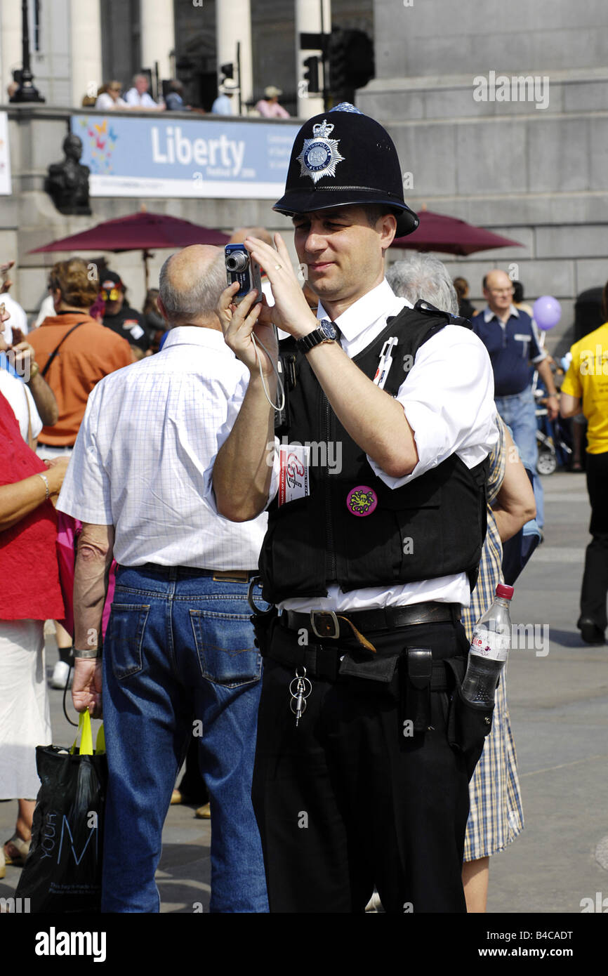 London Police Officer using a small digital camera to possibly ...