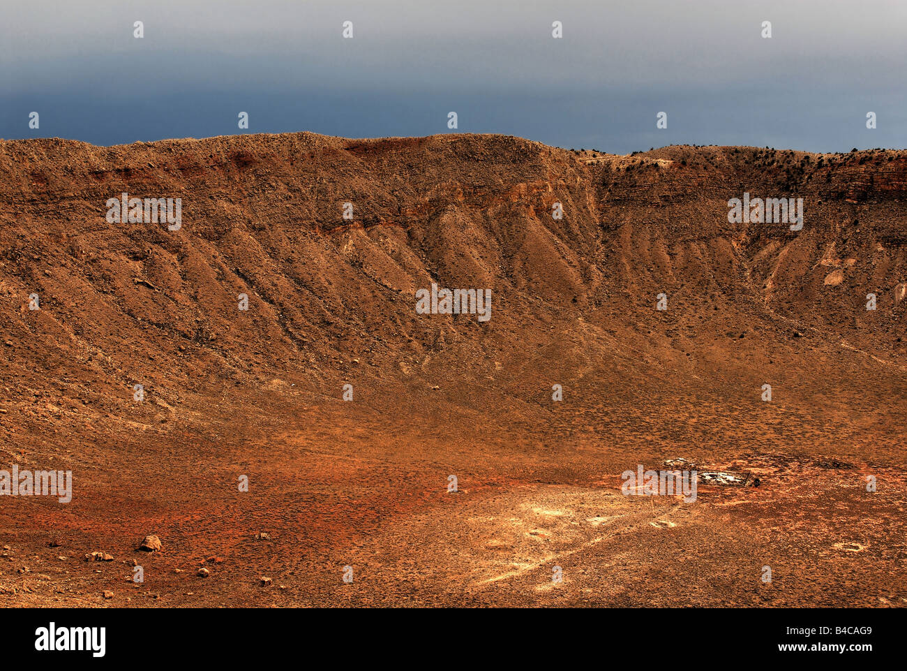 Meteor crater in Arizona with storm approaching Stock Photo - Alamy