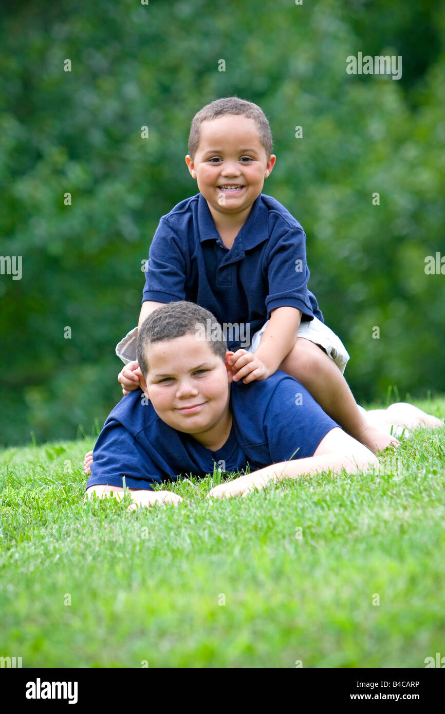 Two brothers playing on fresh green grass Stock Photo - Alamy