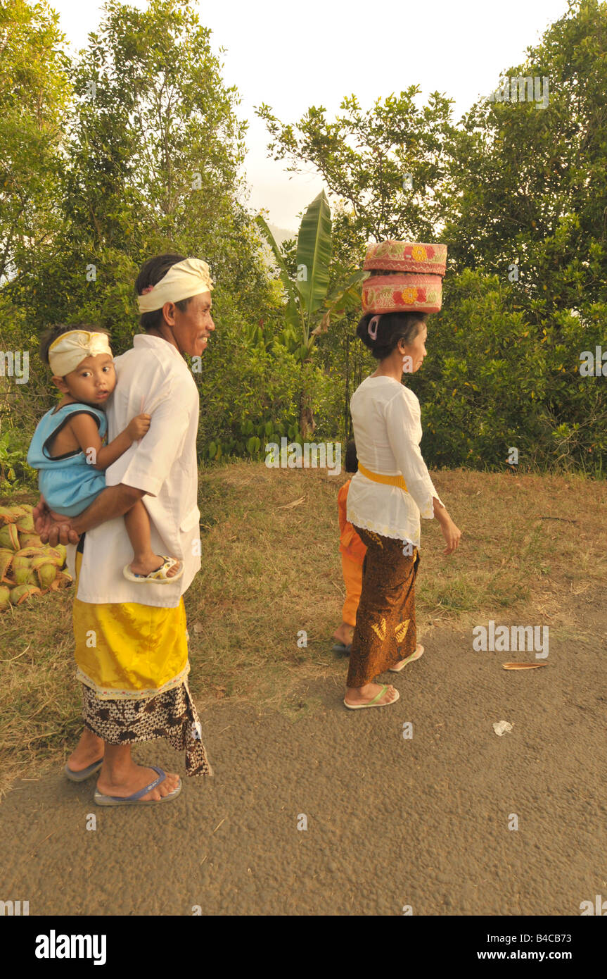 Balinese family coming back from temple to thier home,Bebetin, Bali ...