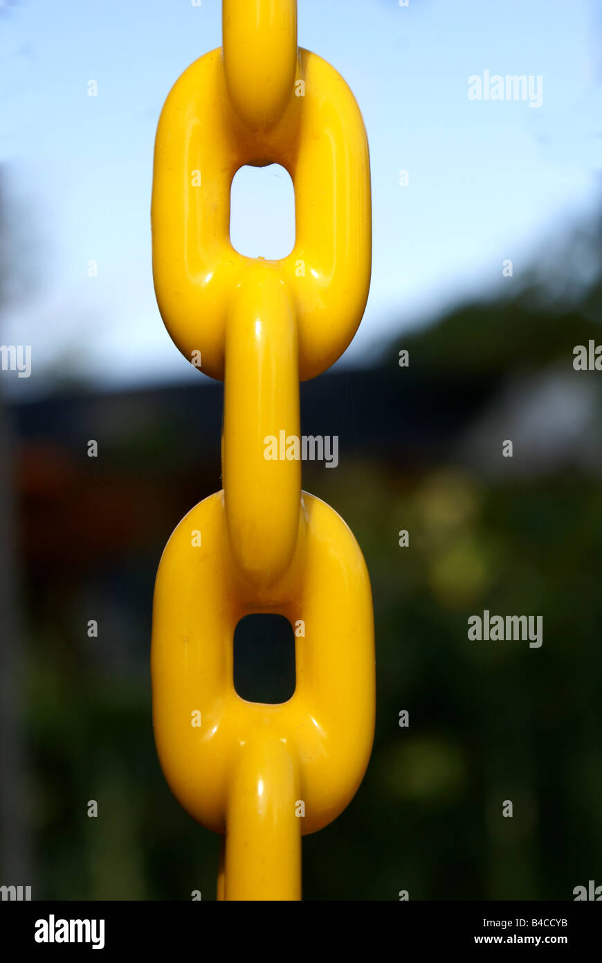 vibrant yellow link chain isolated against blurred background Stock ...