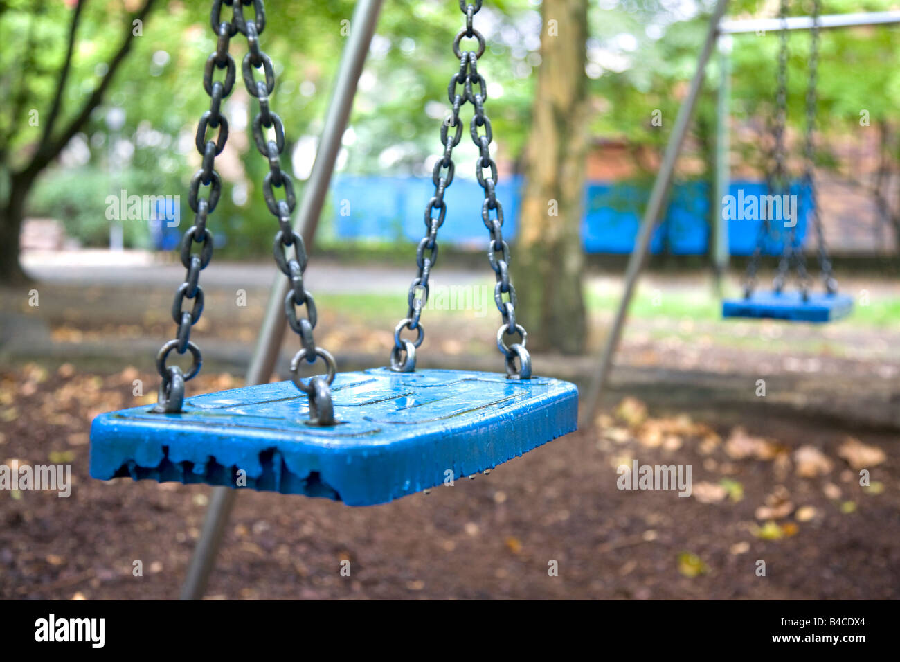 Blue empty swing Stock Photo - Alamy