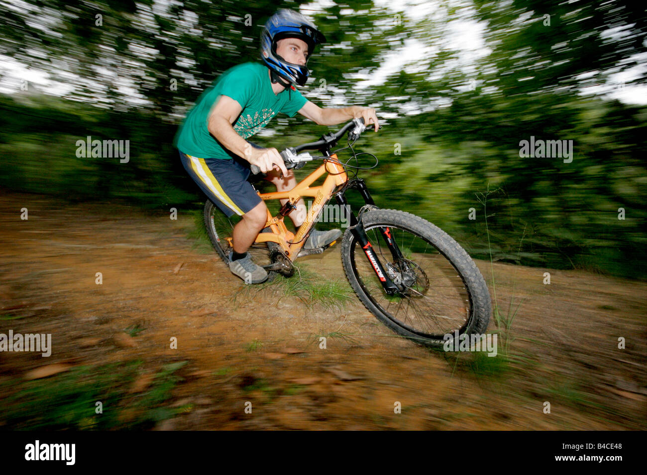 White boy riding a mountain bike downhill Stock Photo - Alamy