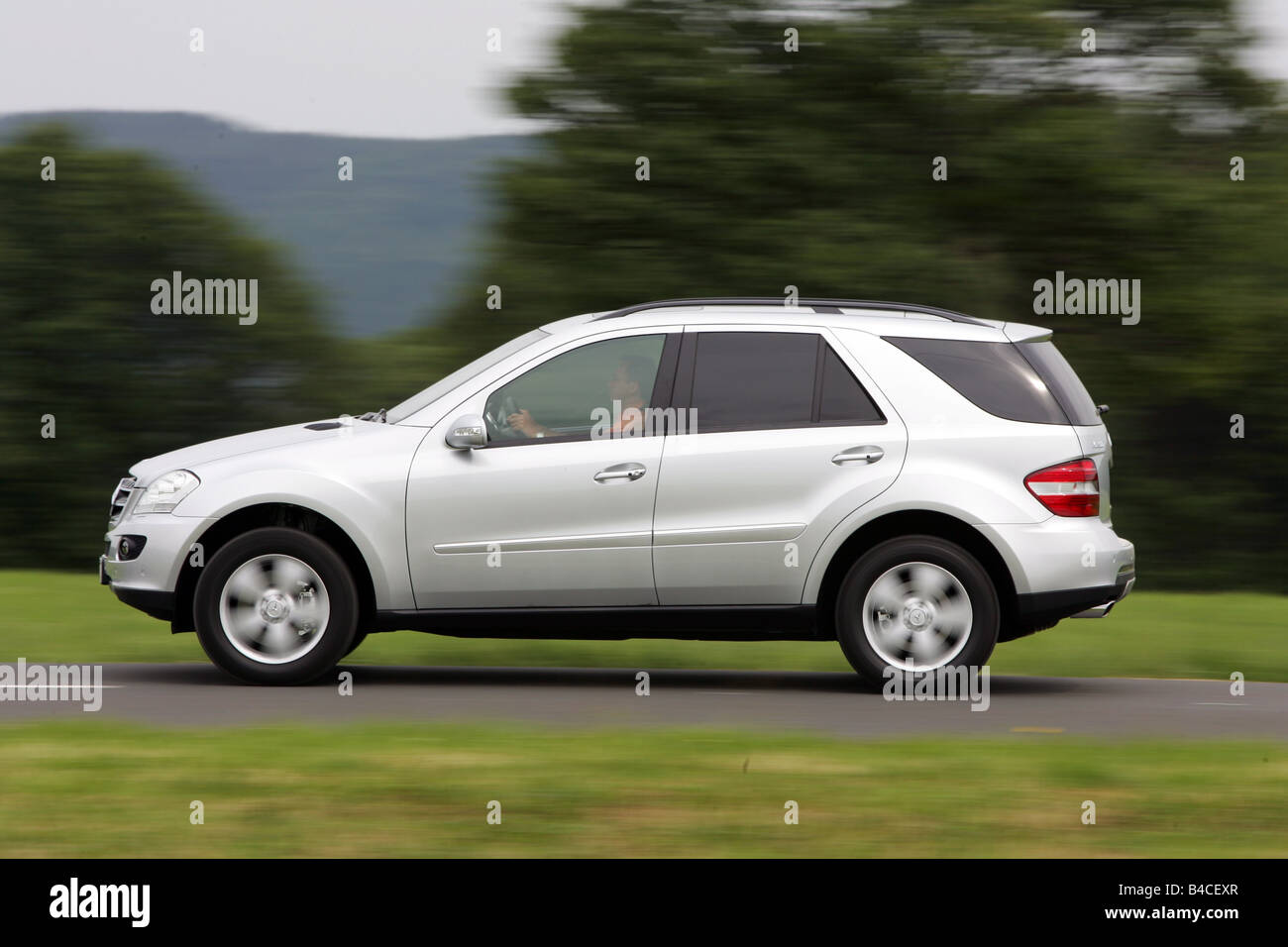 Car, Mercedes ML 500, silver, model year 2005-, driving, side view ...