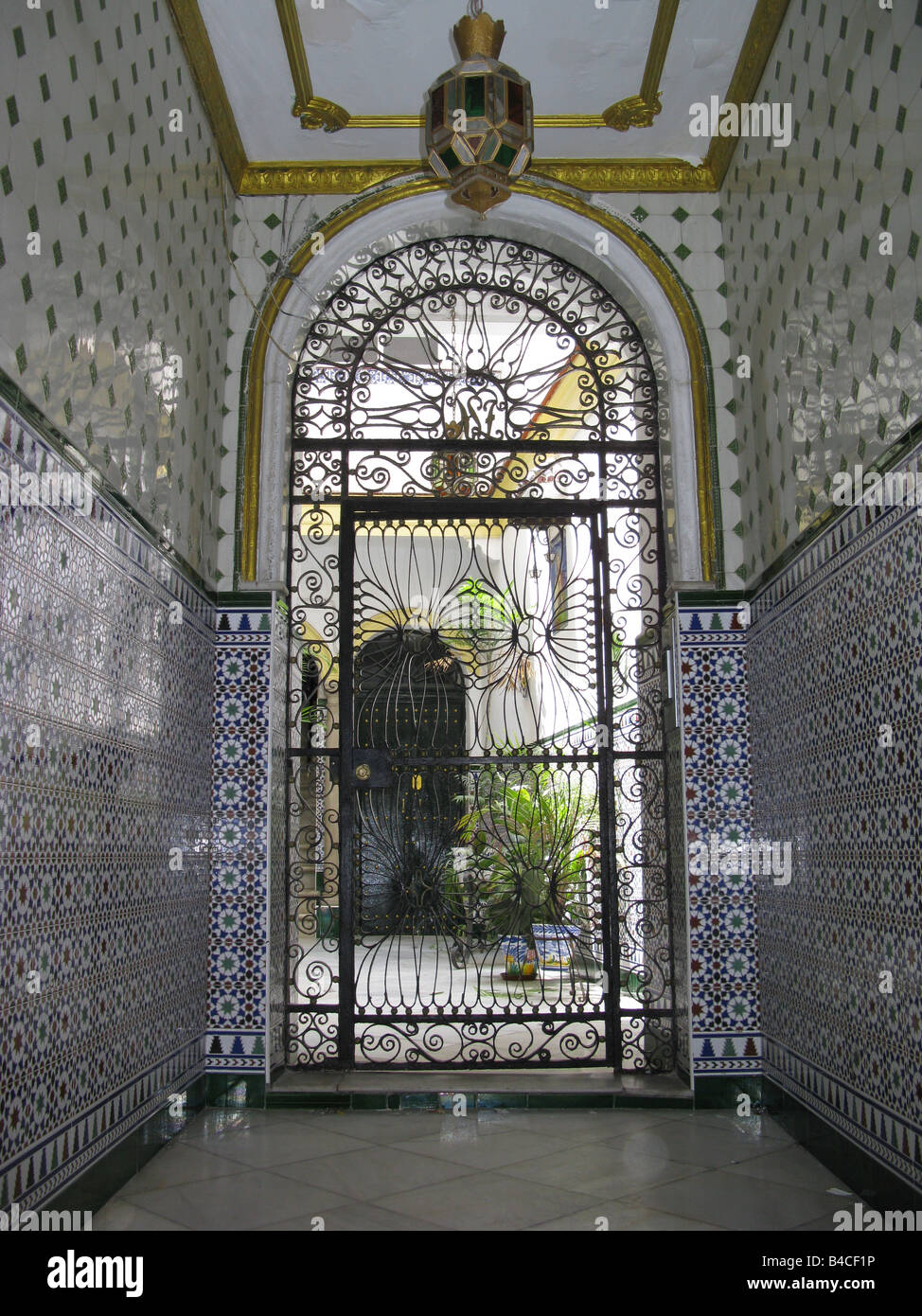 Courtyard gateway decorated with brightly-coloured tiles. Cadiz ...
