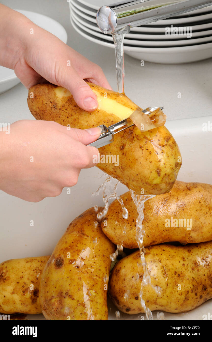 WOMAN PEELING POTATOES Stock Photo - Alamy