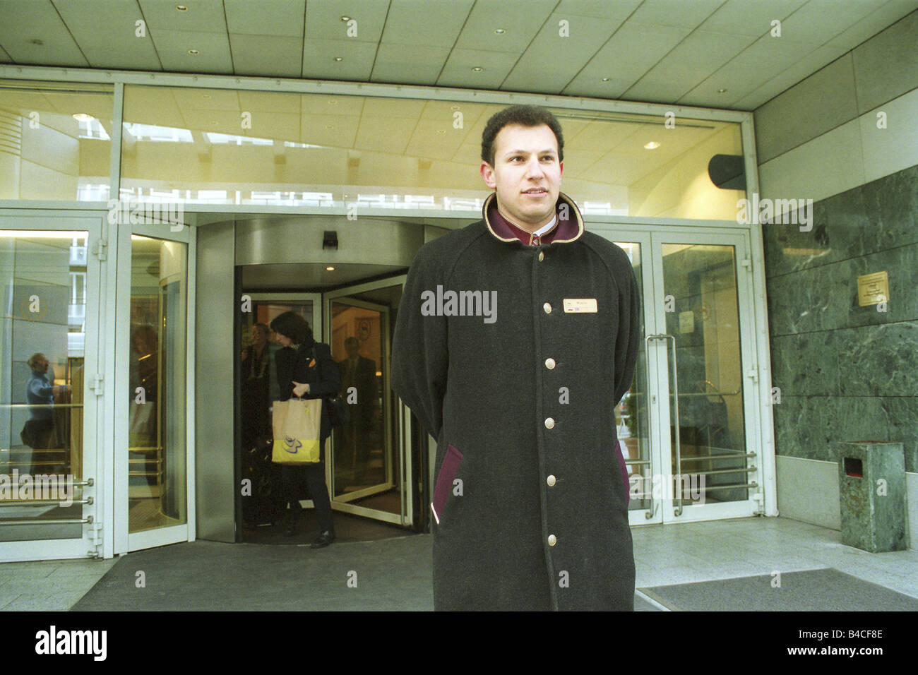 A doorman in front of the entrance to the Sheraton Hotel, Warsaw ...
