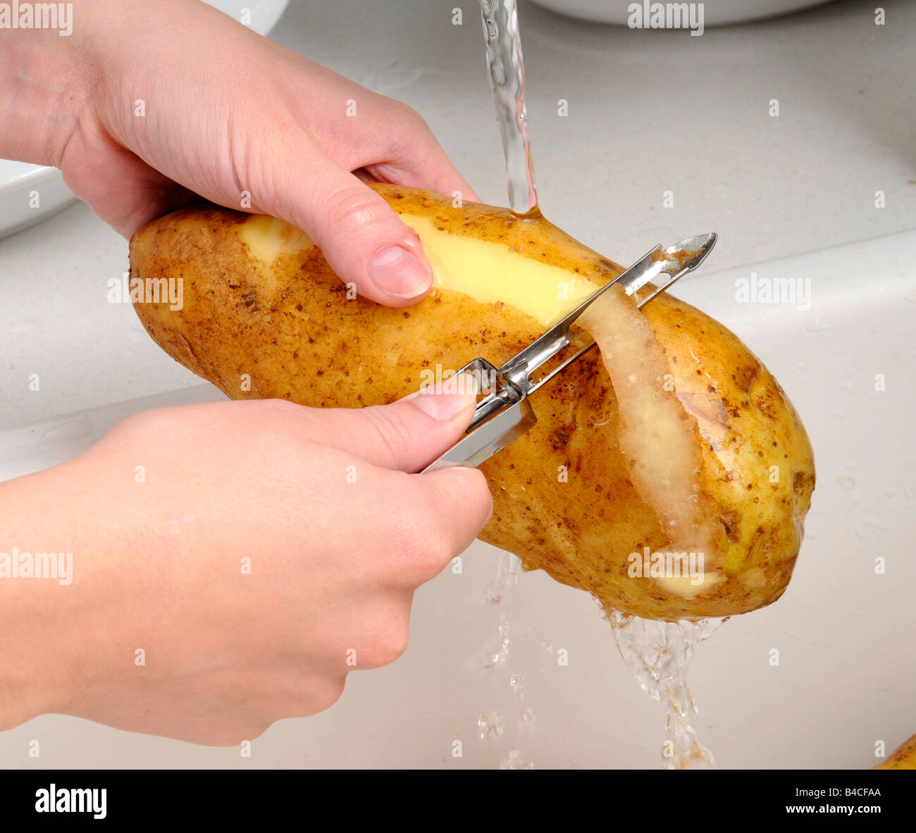 Hand peeling raw potato vegetable hi-res stock photography and images ...