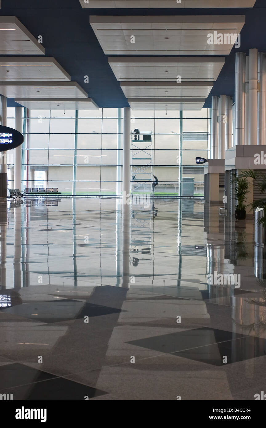 window cleaner at big airport hall Stock Photo - Alamy