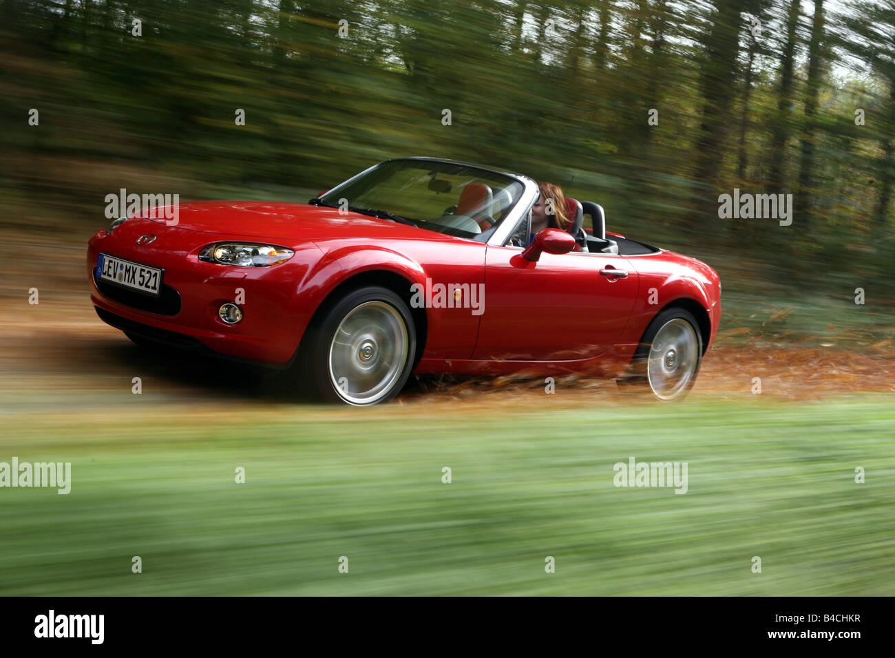 Mazda MX-5, model year 2005-, red, open top, driving, diagonal from the ...
