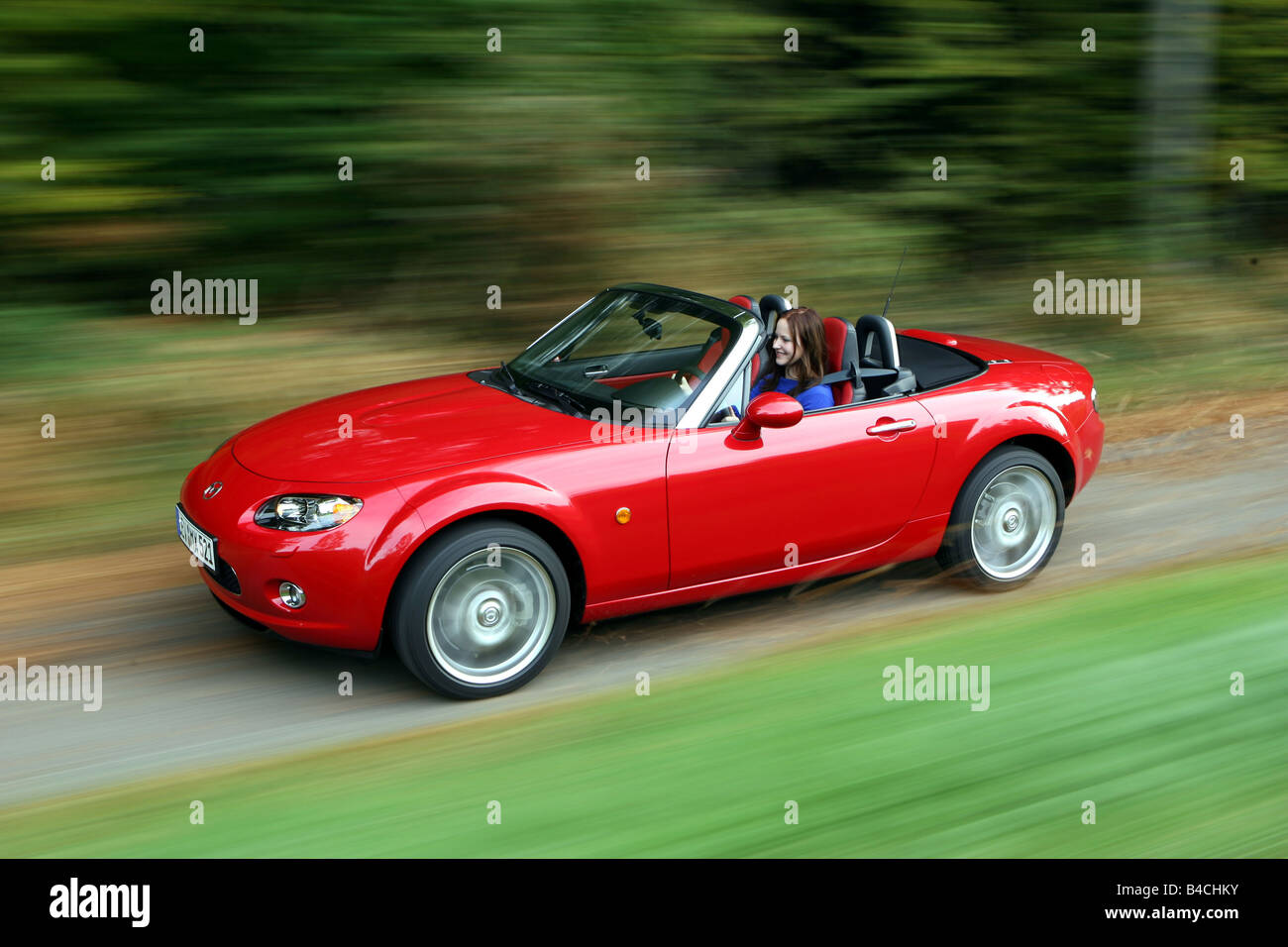 Mazda MX-5, model year 2005-, red, open top, driving, diagonal from the ...