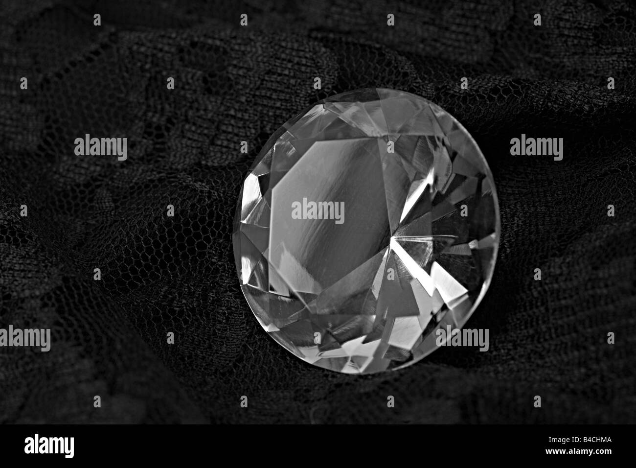 A macro of a diamond lying on black lace Stock Photo - Alamy