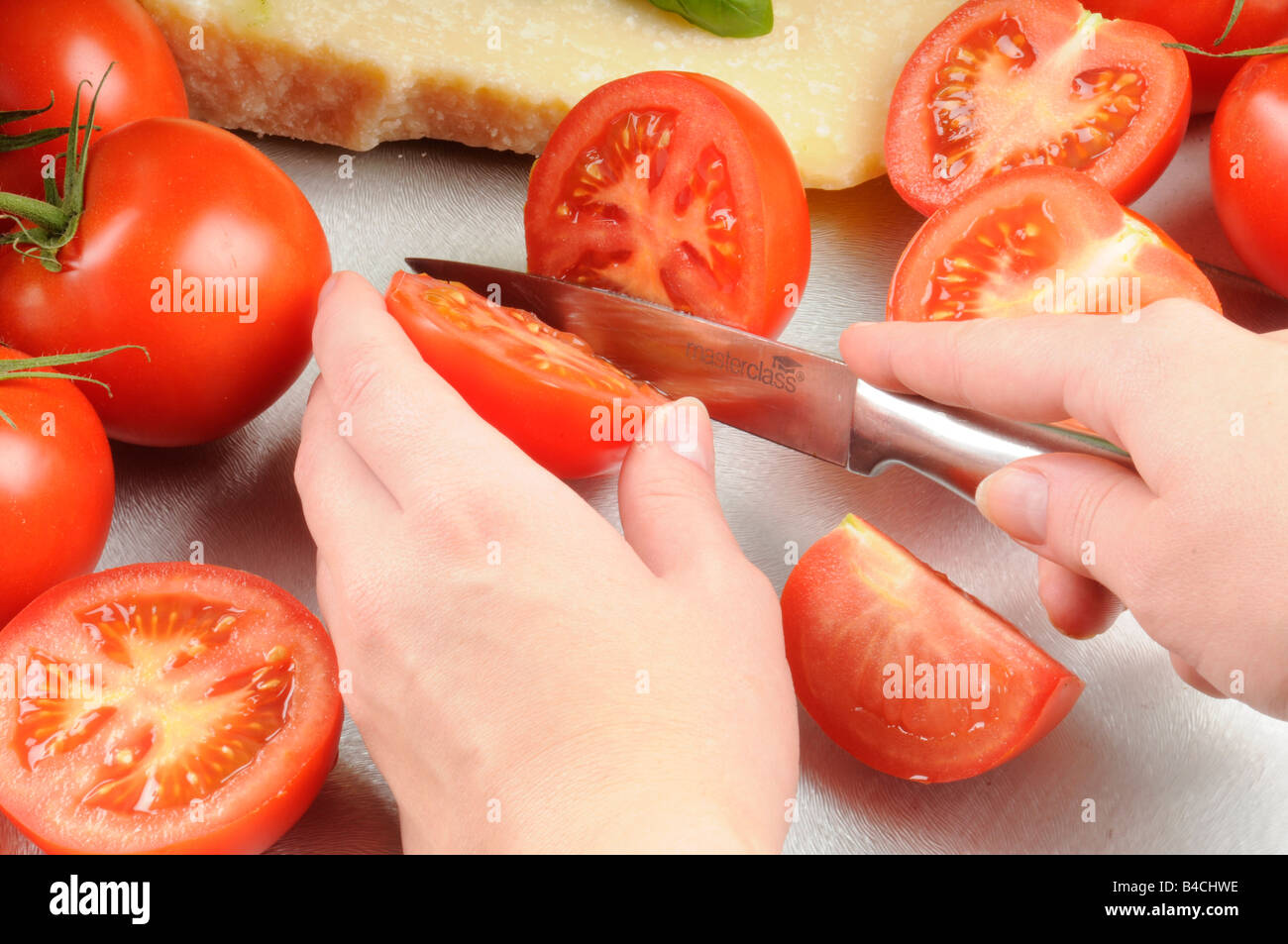 WOMAN SLICING TOMATOES Stock Photo - Alamy