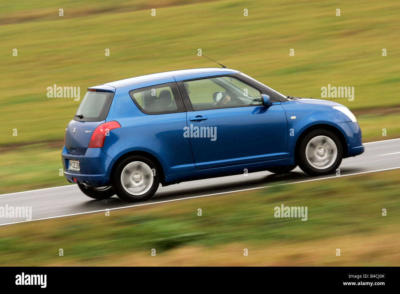Suzuki Swift 1.3, model year 2005, blue moving, diagonal from the back ...