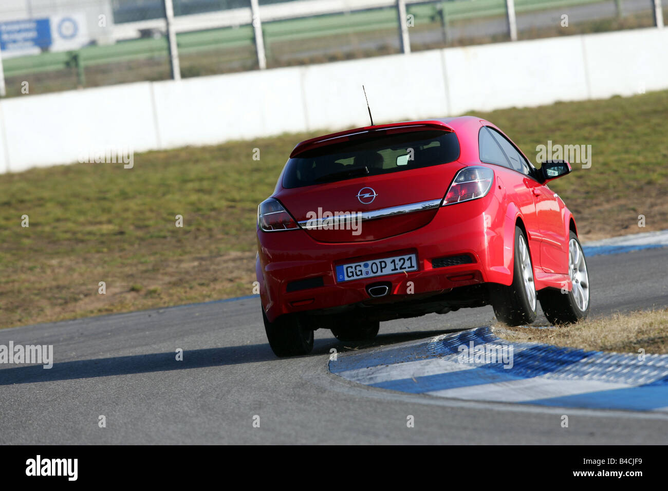 Opel Astra OPC, model year 2004-, red, driving, diagonal from the back ...