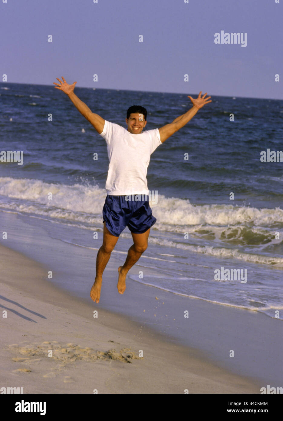 Young man jumping Stock Photo - Alamy