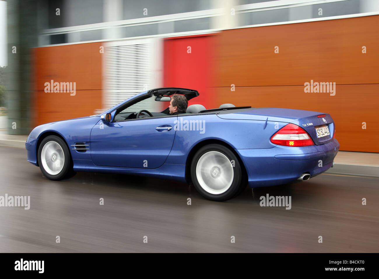 Mercedes SL 500, model year 2005-, blue moving, diagonal from the back ...
