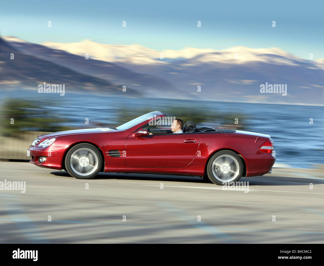 Mercedes SL 500, ruby colored, model year 2006-, driving, side view ...