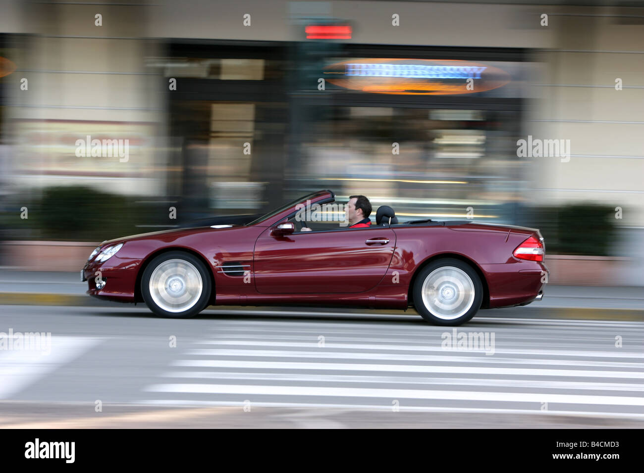 Mercedes SL 500, ruby colored, model year 2006-, driving, side view ...