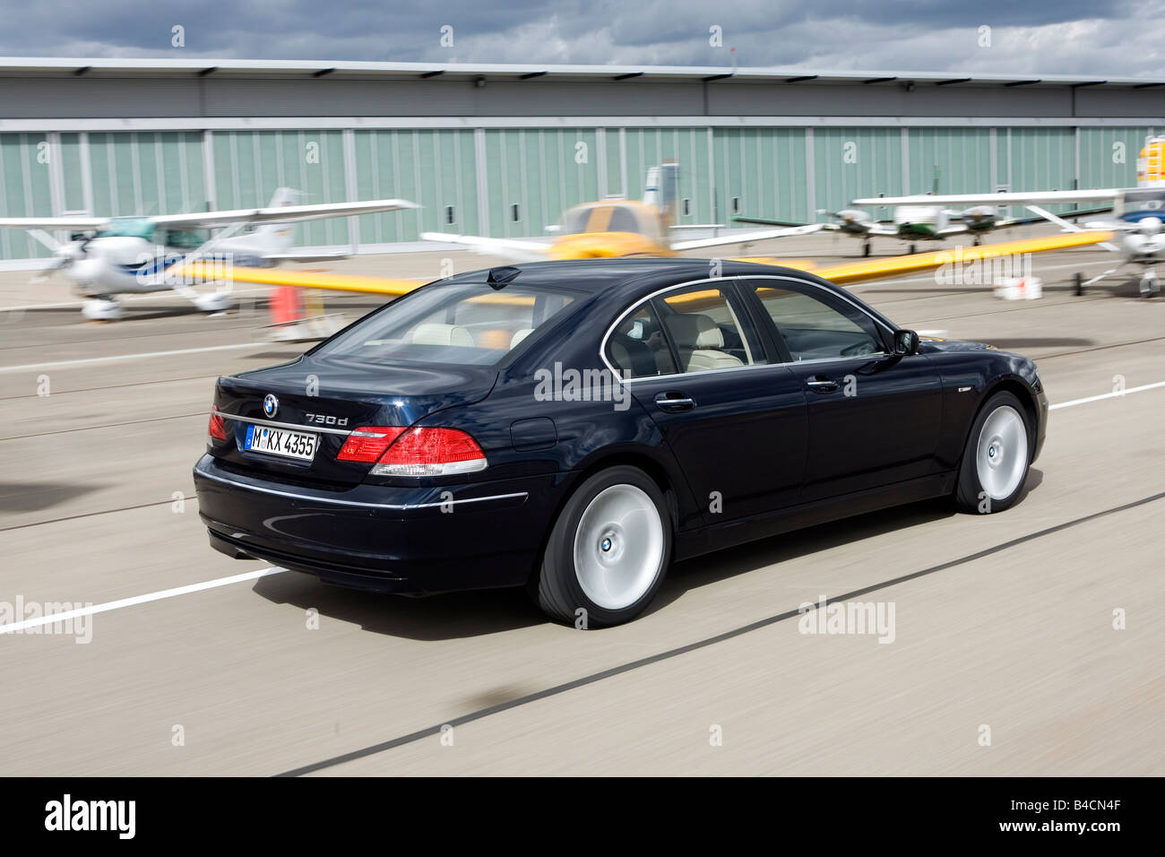 BMW 730d, model year 2005-, black, driving, diagonal from the back ...