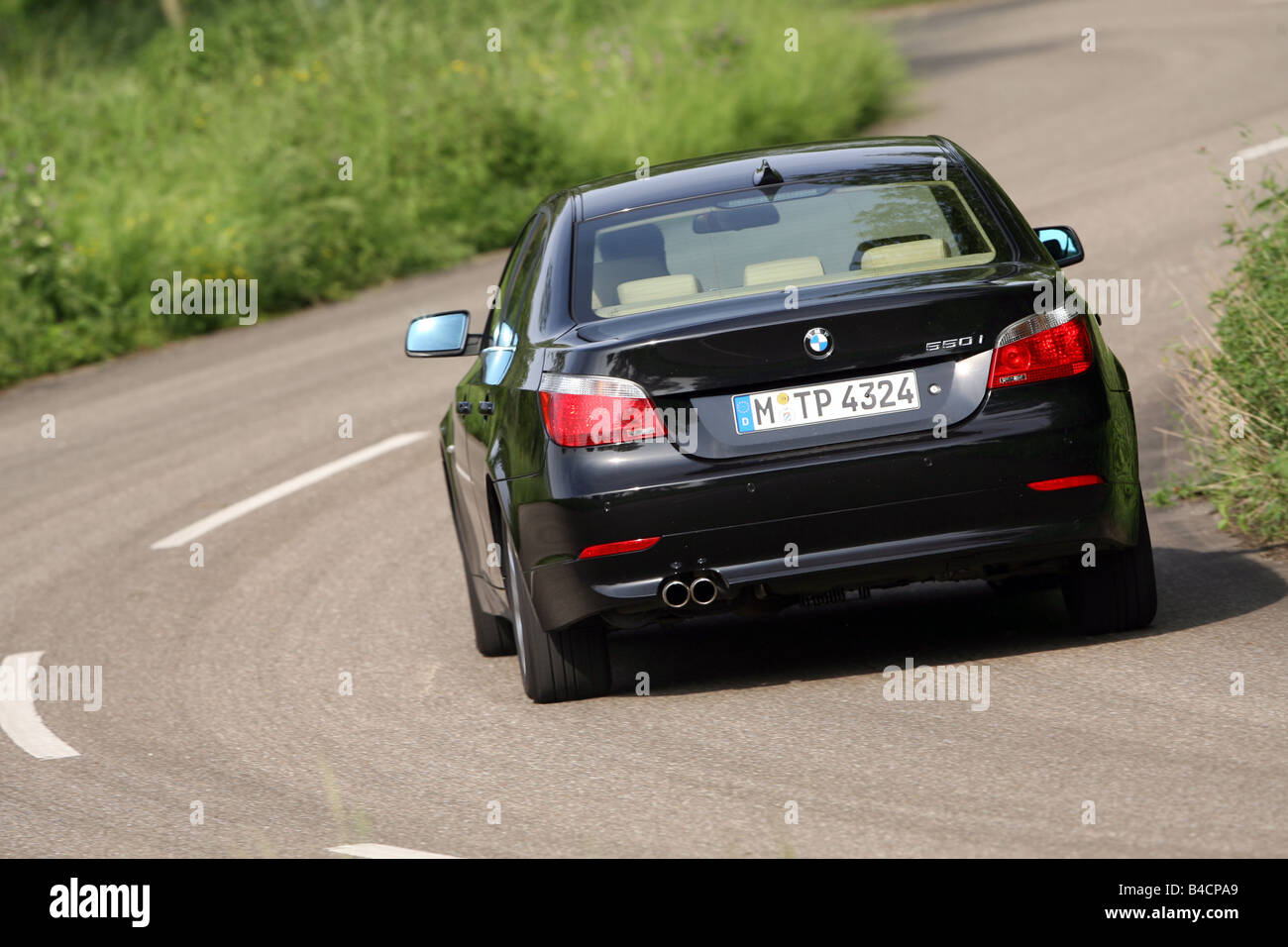 BMW 550i, model year 2005-, black, driving, diagonal from the back ...