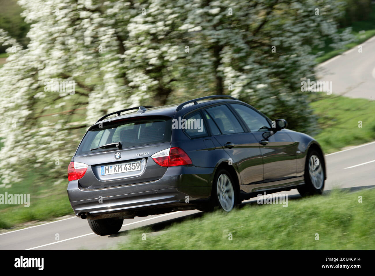 BMW 320i Touring, model year 2006-, black, driving, diagonal from the ...