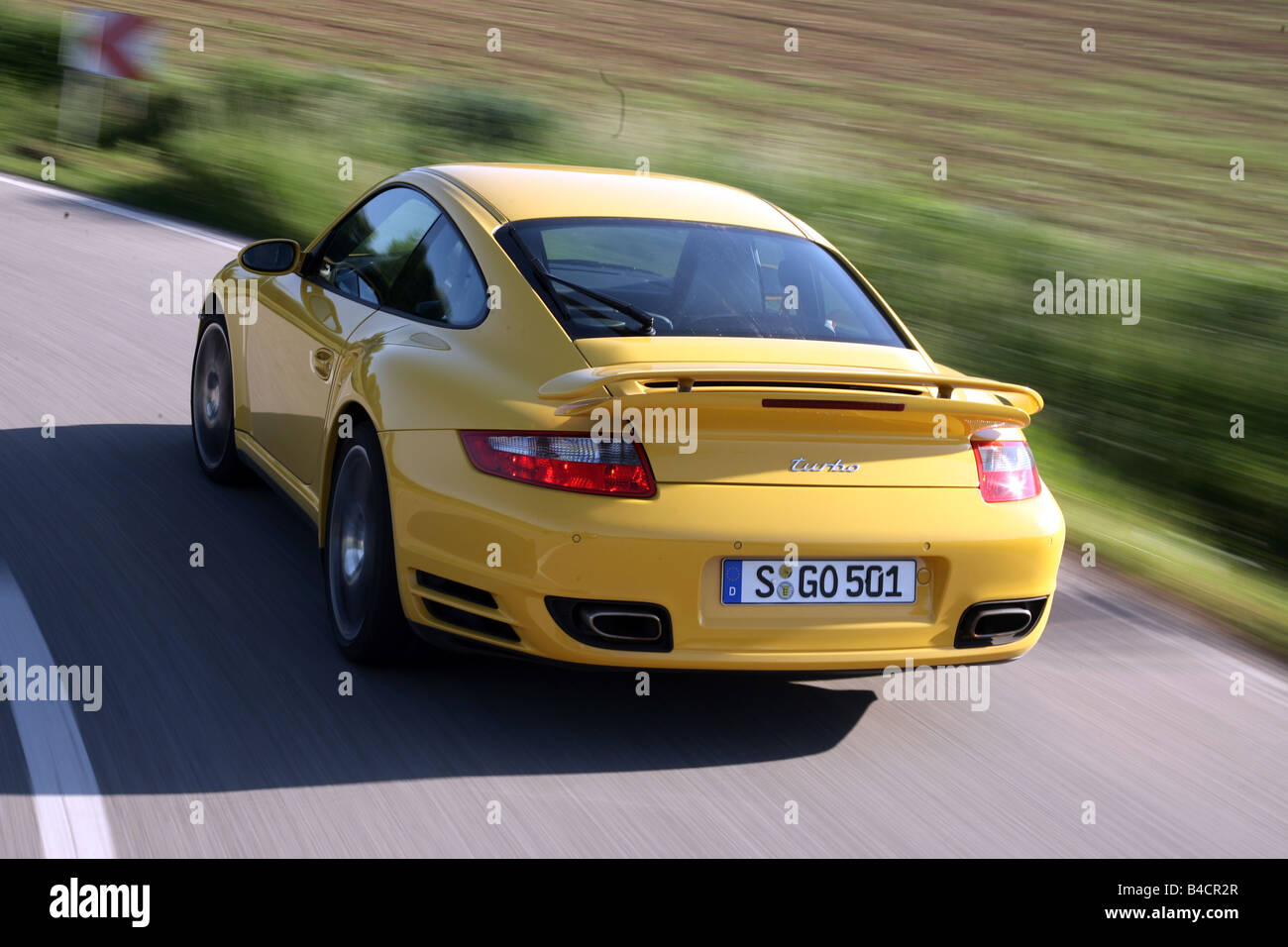 Porsche 911 Turbo, model year 2006-, yellow, driving, diagonal from the ...