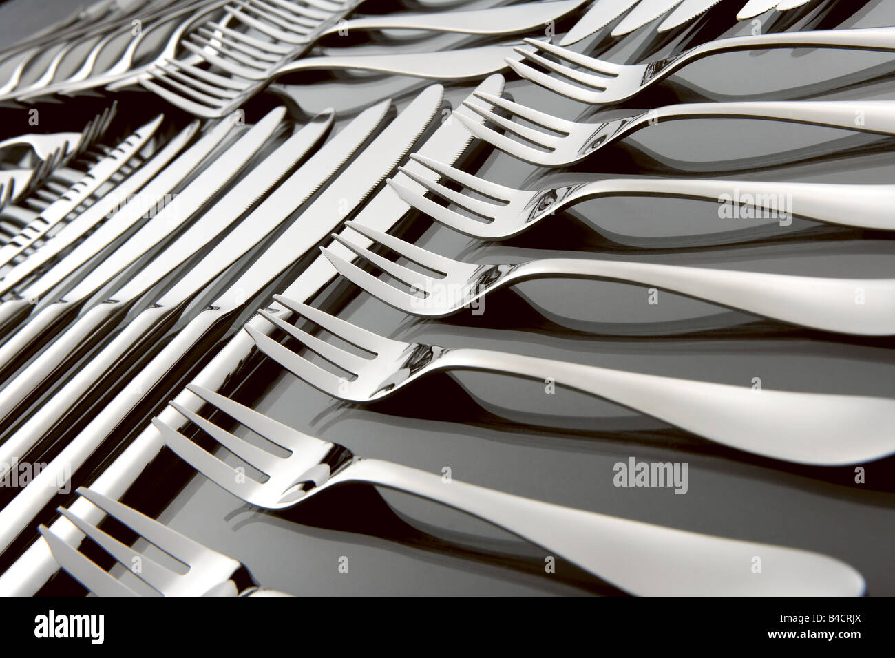 Silver Stainless Steel Cutlery Set on a Graduated Black Background With ...