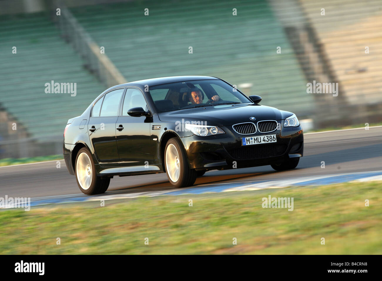 BMW M5, model year 2005-, black, driving, diagonal from the front ...