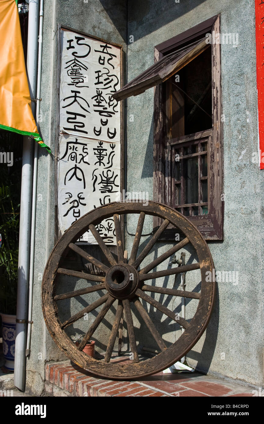 Cartwheel leaning against a wall and window, Lugang, Taiwan, Republic ...