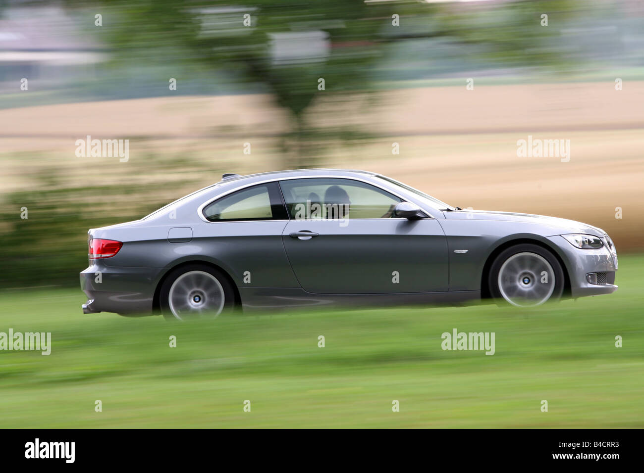 BMW 335i Coupe, model year 2006-, anthracite, driving, side view ...