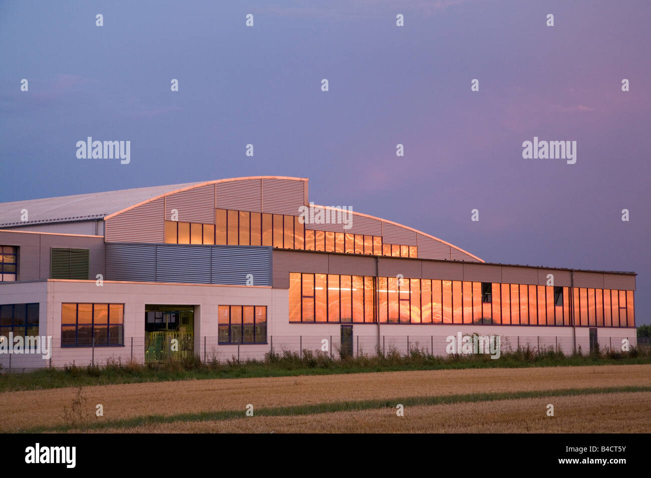 Factory on the outskirts of Kosching with the sunset reflecting in its ...