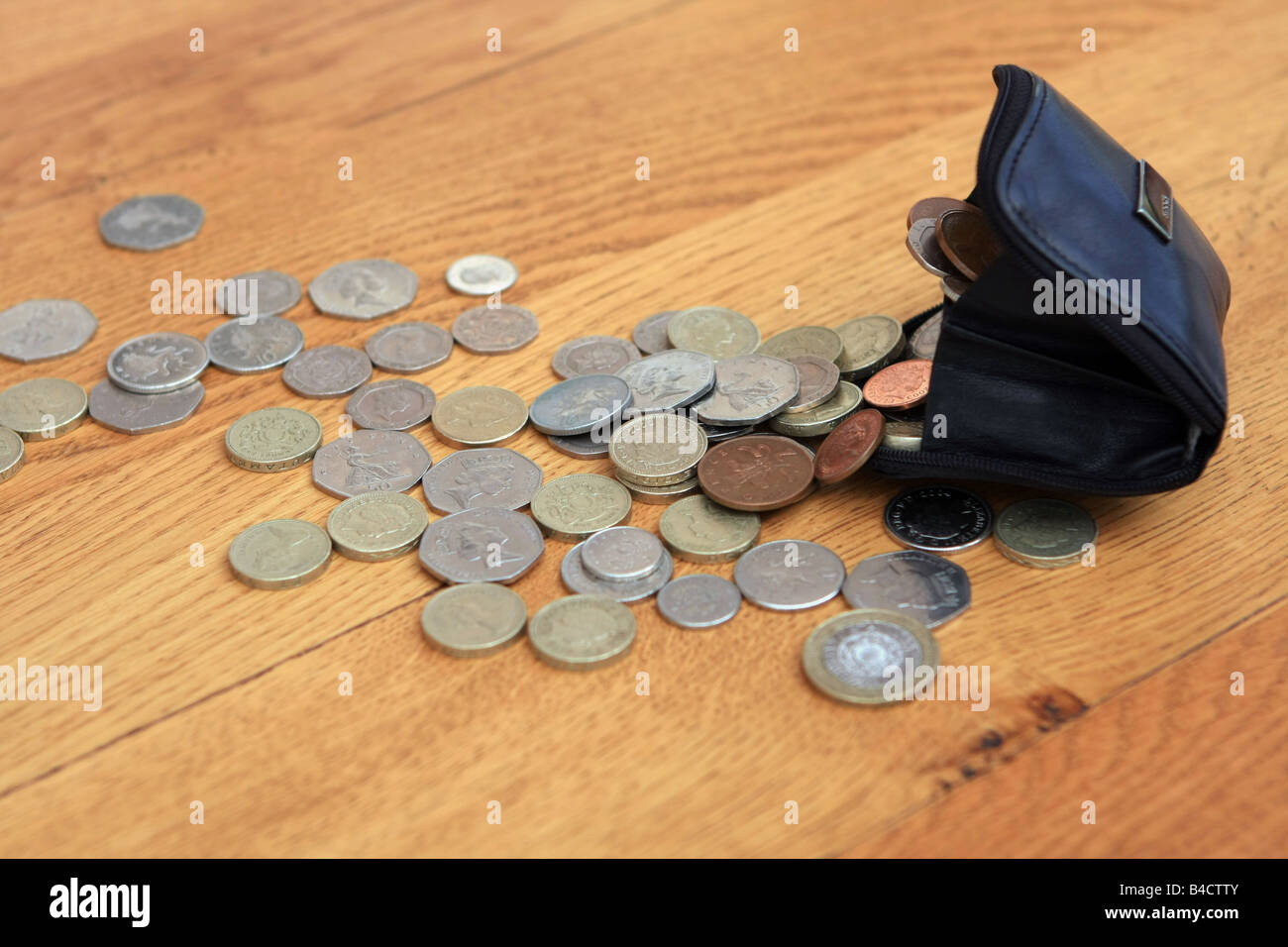 Open coin purse spilling hi-res stock photography and images - Alamy