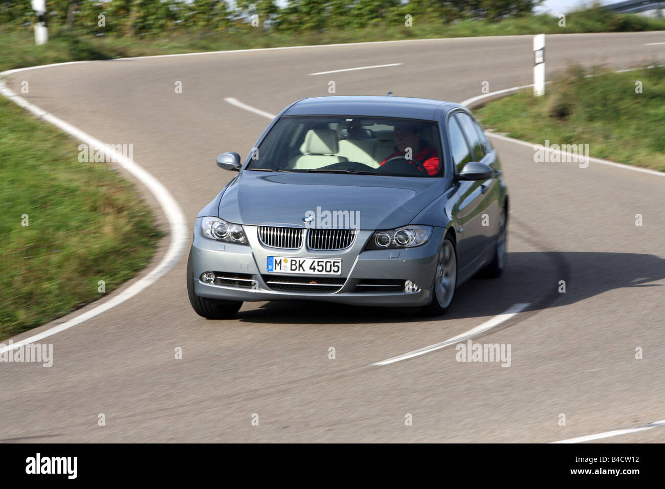 BMW 335i, model year 2006-, silver, driving, diagonal from the back ...