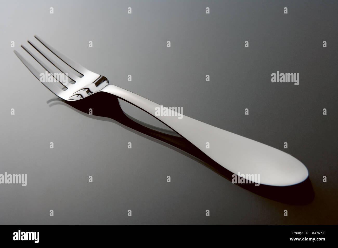 Silver Stainless Steel Fork on a Graduated Black Background With ...