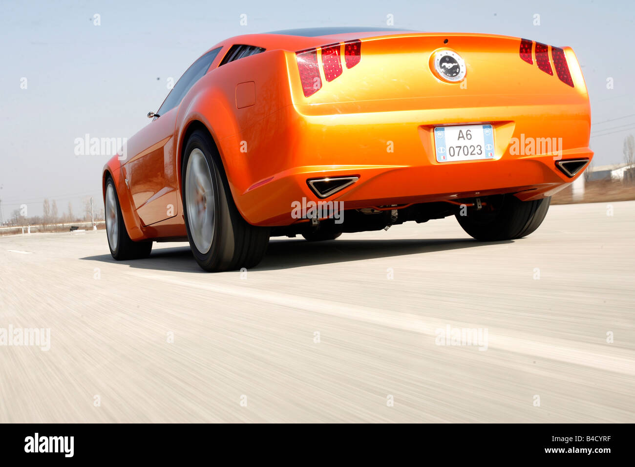 Ford Mustang by Giugiaro, model year 2007, orange -metallic, driving ...