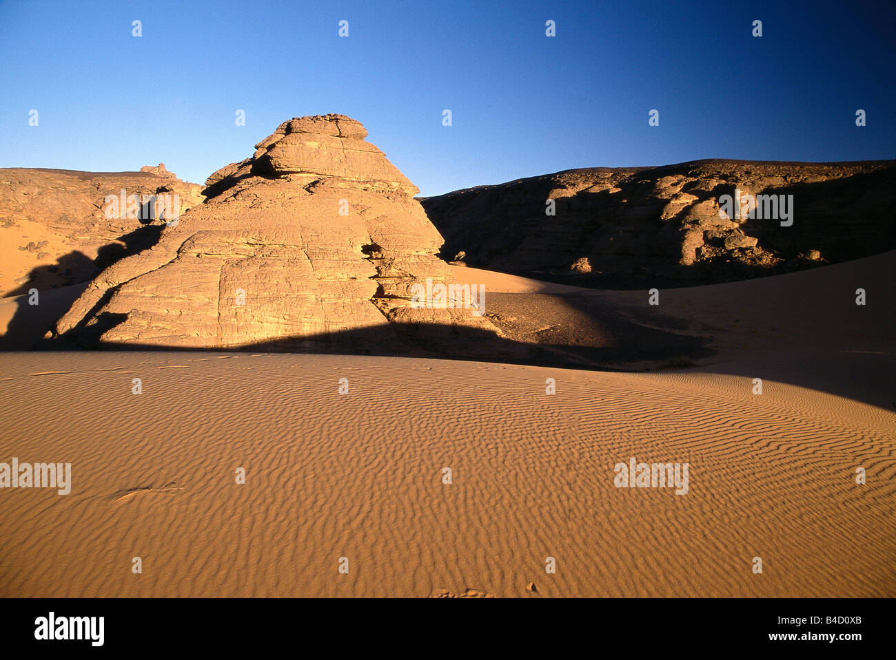 Sand dunes and rocky mountains at Jebel Acacus, Sahara Desert, Libya ...