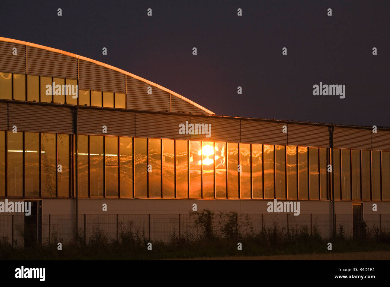 Factory on the outskirts of Kosching with the sunset reflecting in its ...