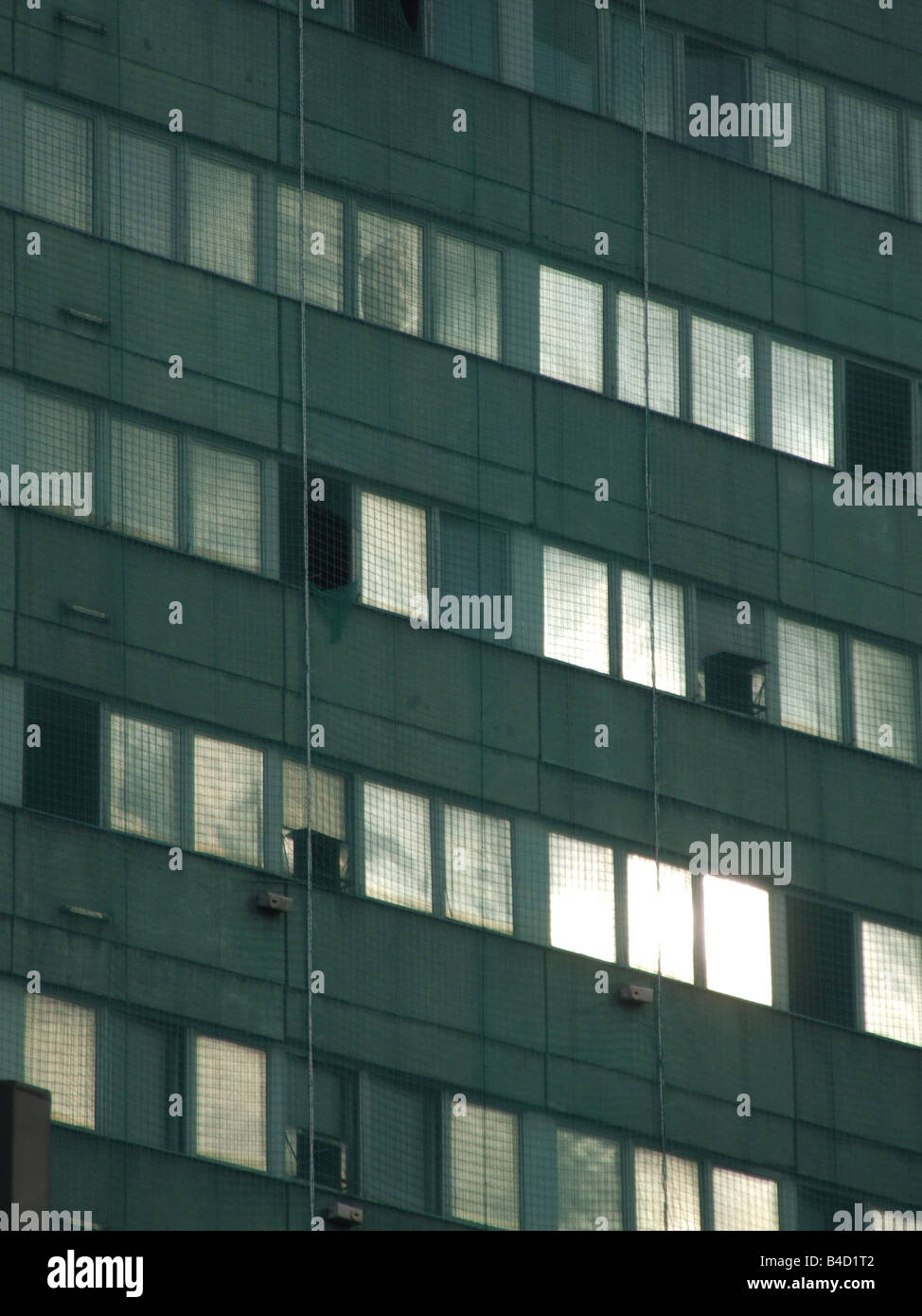 high rise building with green protective mesh net Stock Photo - Alamy