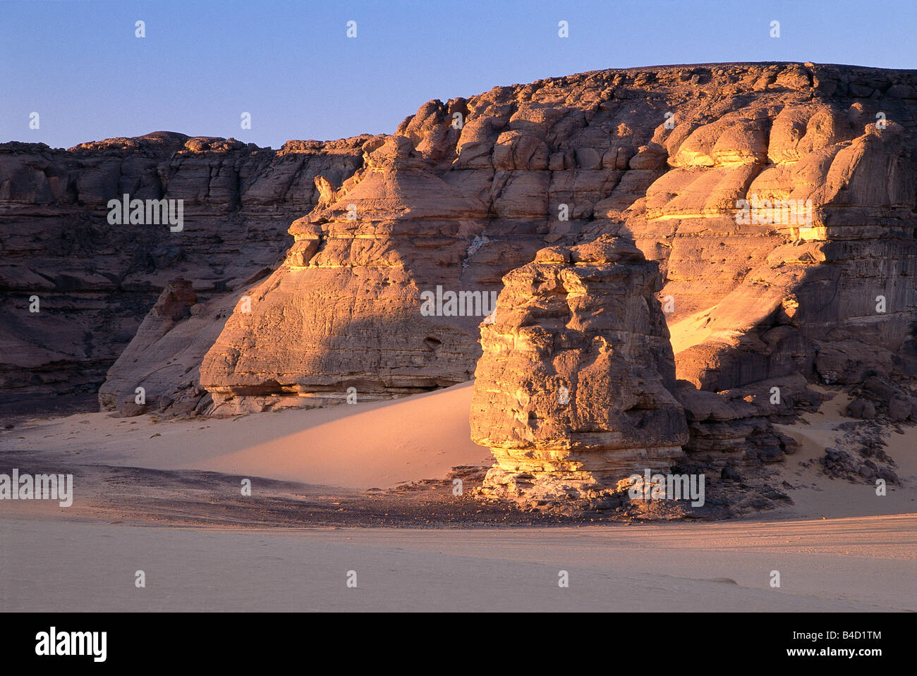 A ridge rears above a valley in Jebel Acacus, Sahara Desert, Libya ...
