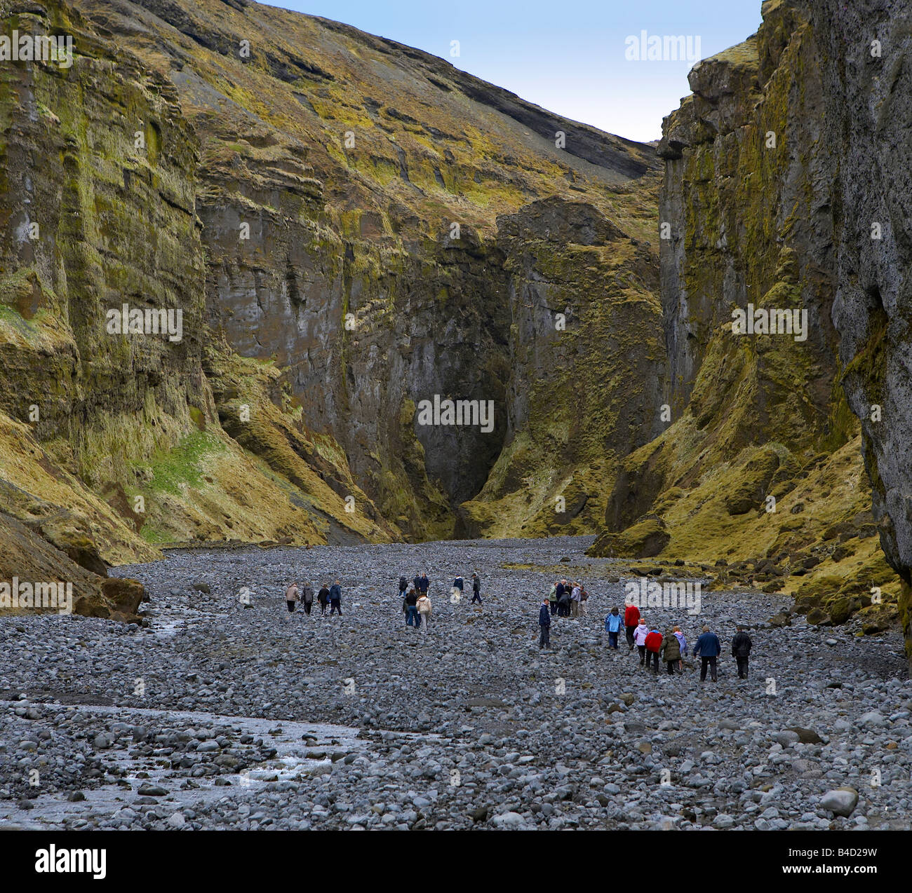 People hiking between moss covered cliffs, Thorsmork, Iceland Stock ...