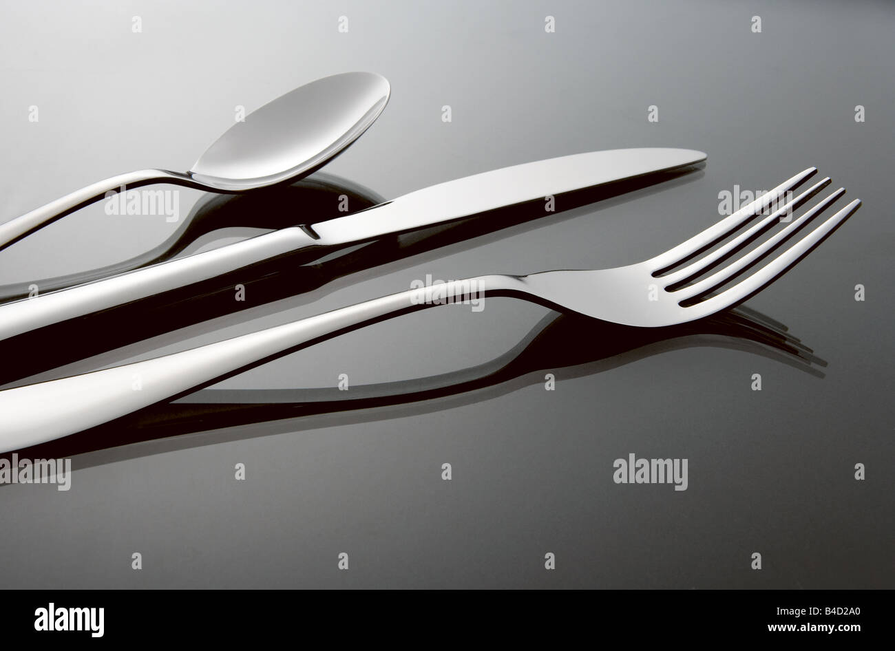 Silver Stainless Steel Cutlery Set on a Graduated Black Background With ...