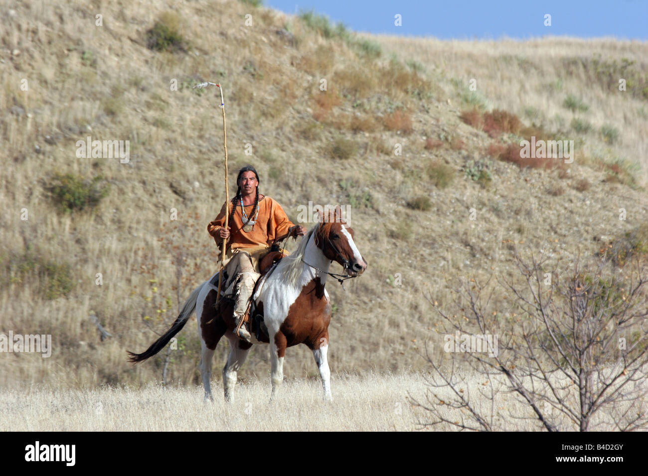 A Native American Lakota Sioux Indian riding horseback on the prairie ...