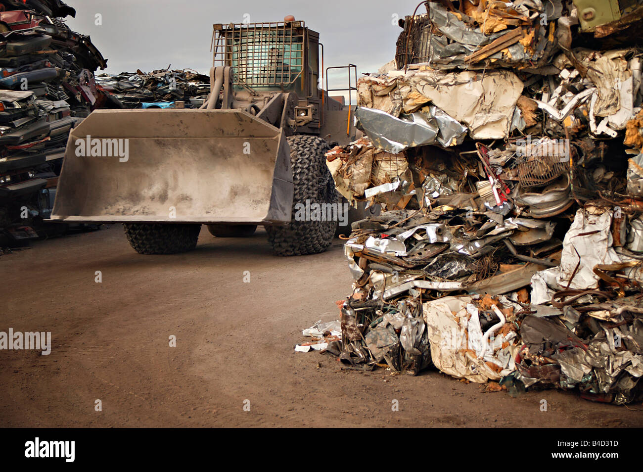 A tractor driving through stacks of compacted rubbish Stock Photo - Alamy