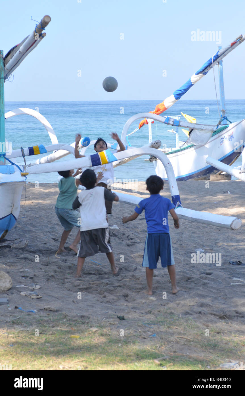 Children are playing volleyball by using boat as a net,Bali,Indonesia ...