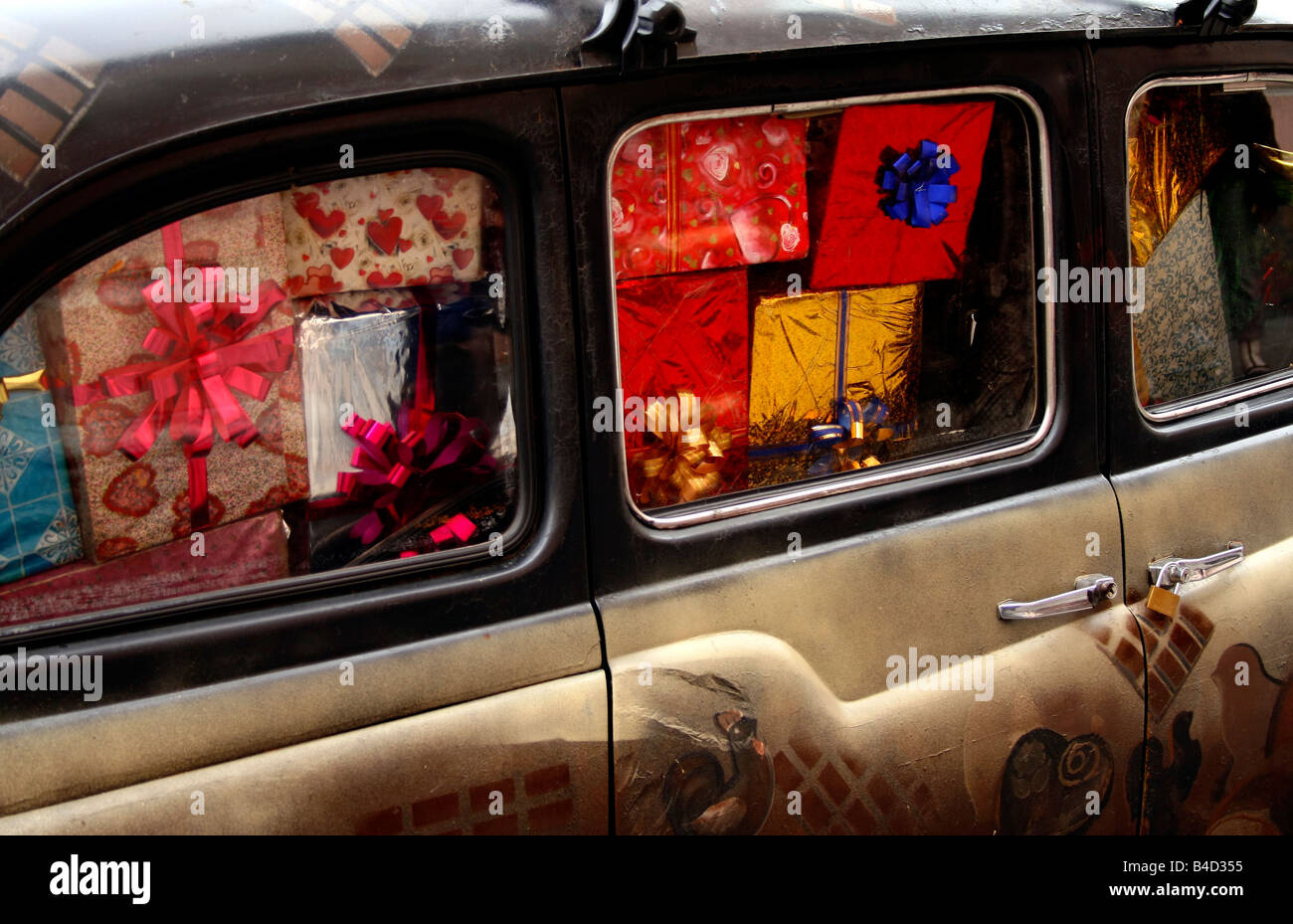 Colorful wrapped gift boxes in an old (antique) car Stock Photo - Alamy