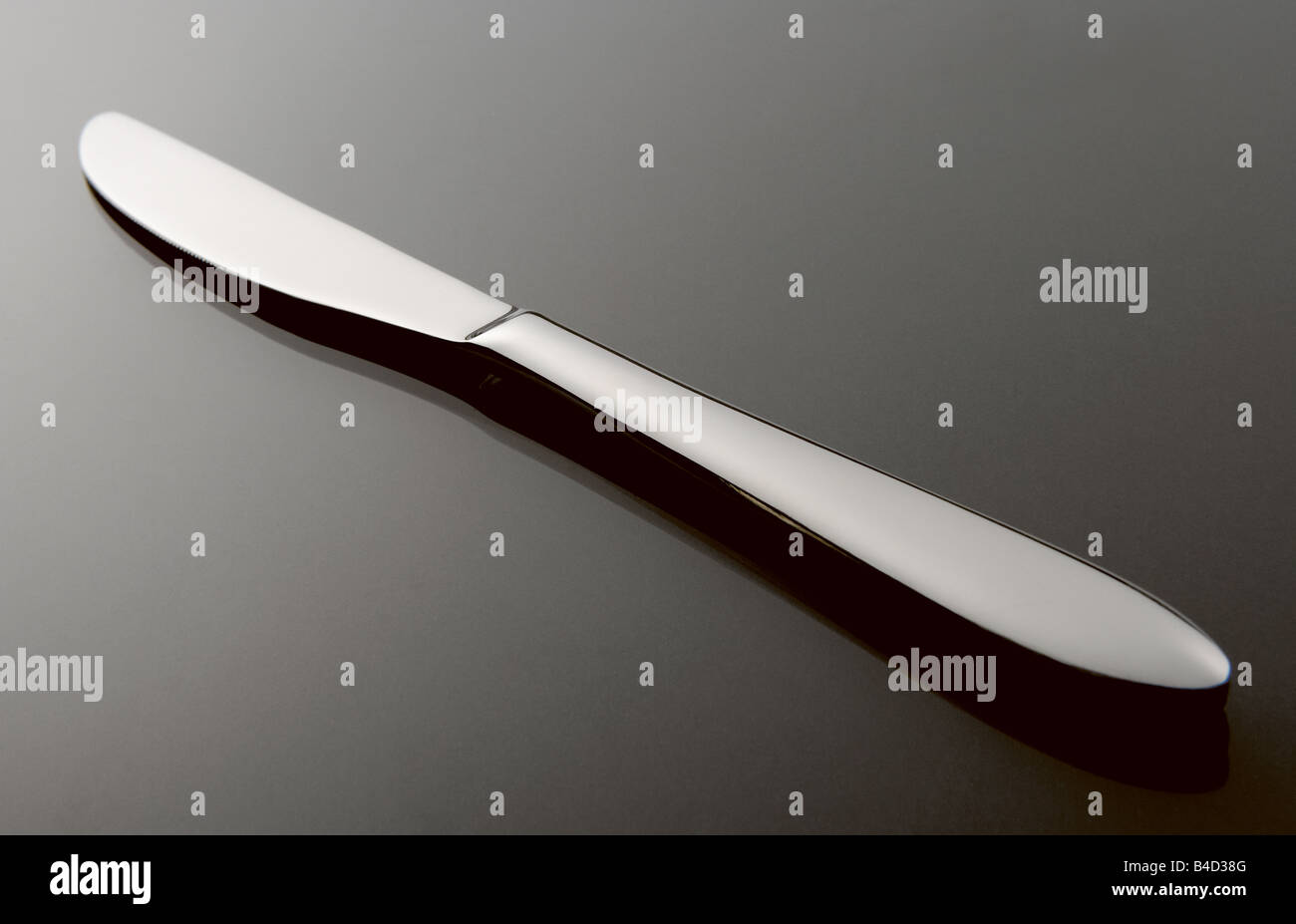 Silver Stainless Steel Knife on a Graduated Black Background With ...