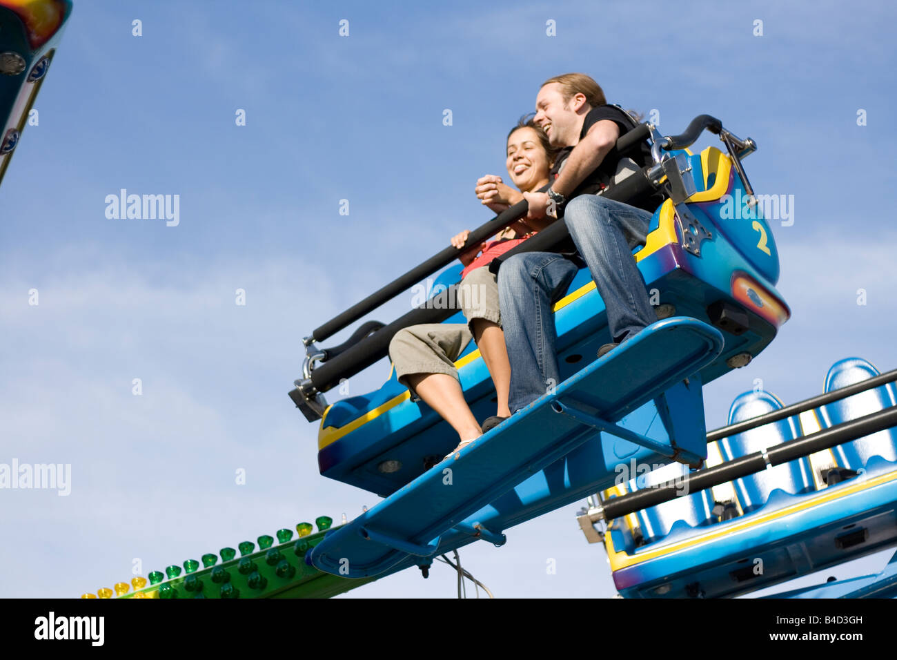 A couple on a fun fair ride Stock Photo - Alamy